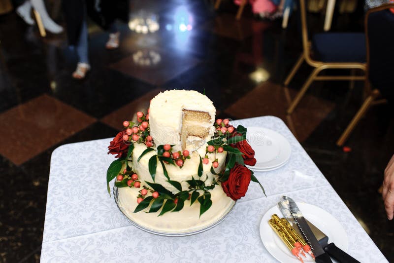 Wedding Cake with a Cut Piece on a White Tablecloth Stock Photo - Image ...