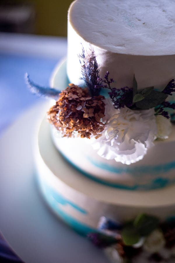 Three-tier Cake, White with Blue Spots, Decorated with Flowers, on a ...