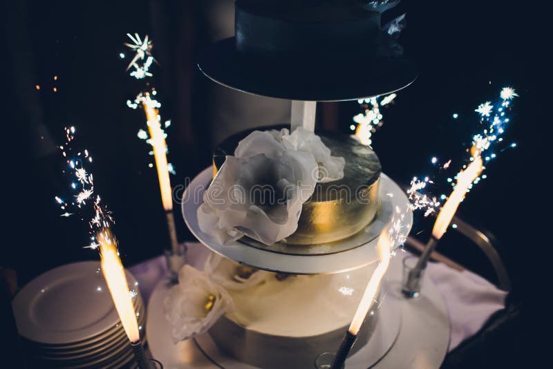 The Wedding Cake with Fireworks Stand on the Table in Restaurant. Stock ...