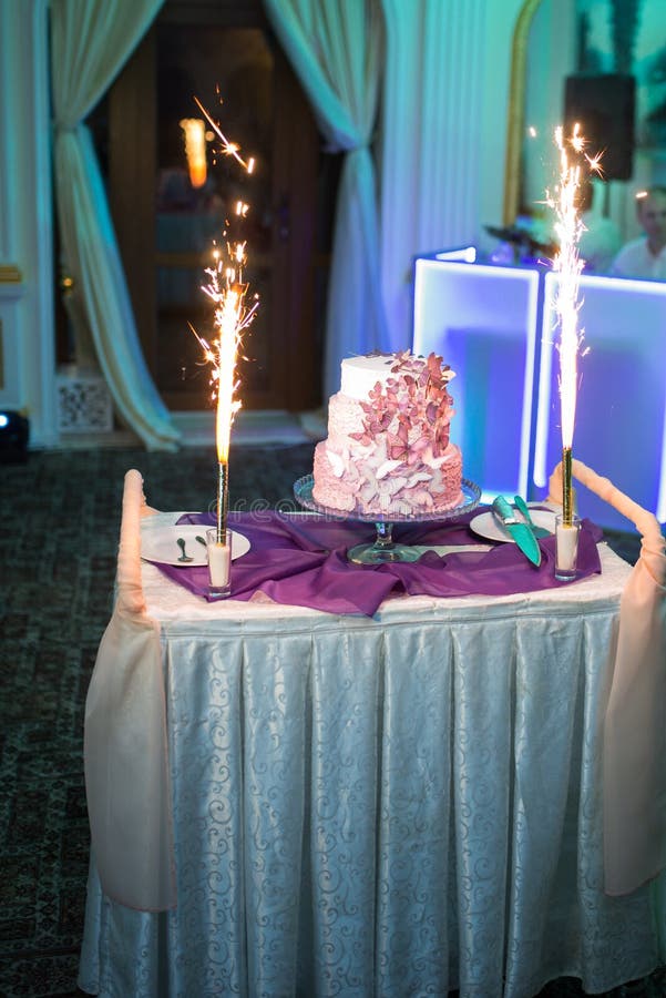 The Wedding Cake with Fireworks Stand on the Table in Restaurant Stock ...