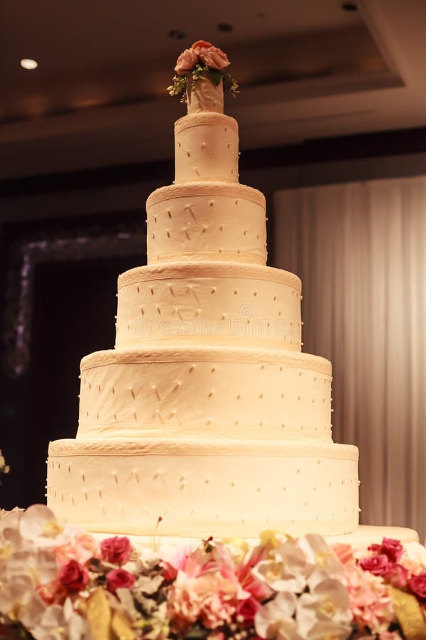 Wedding Cake on the Table Decorated by Beautiful Flowers at the Stage ...