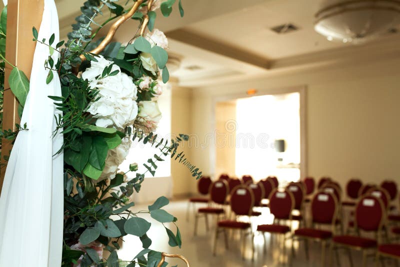 Wedding Ceremony Hall Decorated with Fresh Flowers. Blurred Chairs for ...