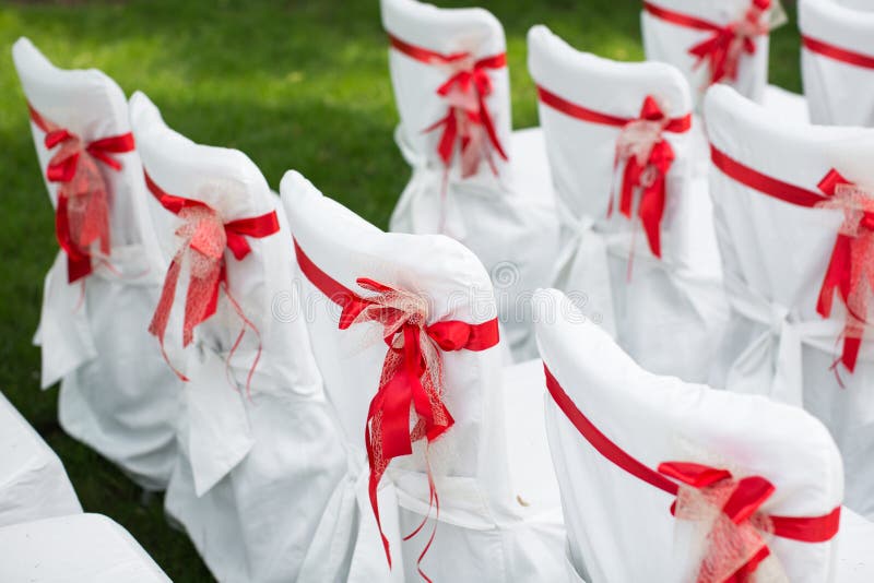 Wedding Ceremony Outdoors. White Chairs with Red Ribbon. Stock Photo ...