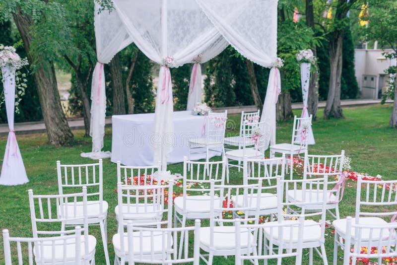 Wedding or Ceremony Set Up in Garden, White Chairs Stock Photo - Image ...