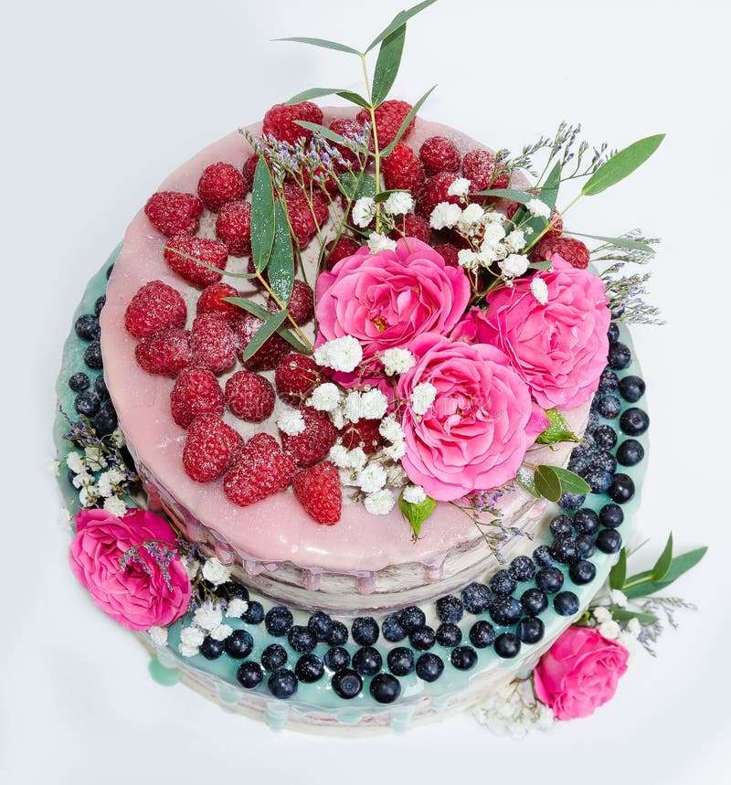 Wedding Color Drip Cake with Roses, Blueberries and Raspberries Stock ...