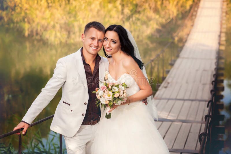 Wedding couple on bridge stock photo. Image of outdoor - 80922346