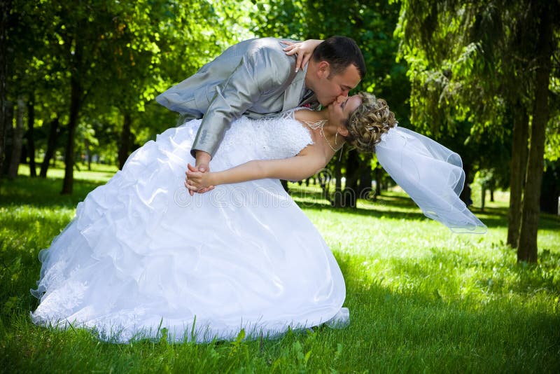 Wedding Couple Kiss in the Park Stock Photo - Image of sunlight ...
