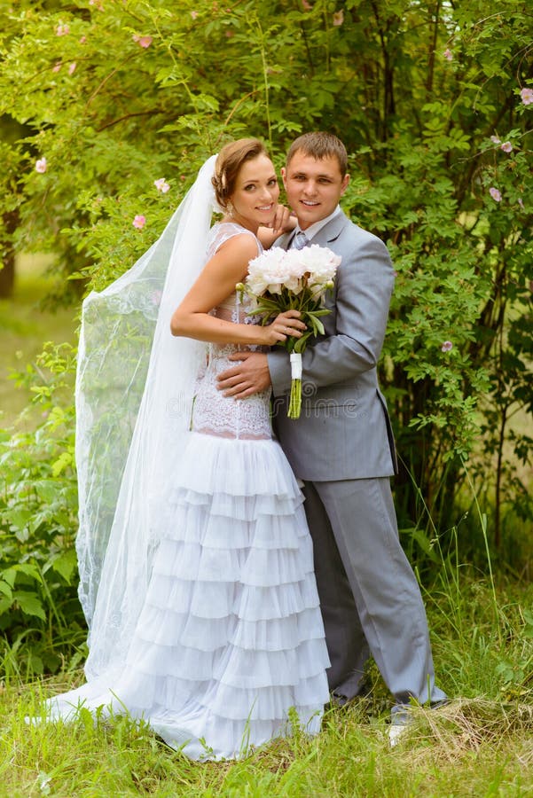 Wedding couple in park stock image. Image of floral, green - 69927775
