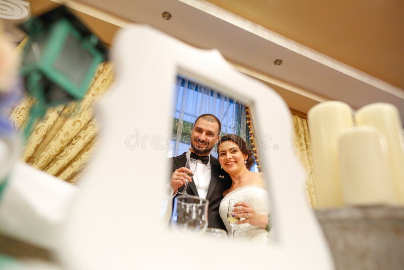 Wedding Couple Posing in Front of Frame in Restuarant Stock Photo ...