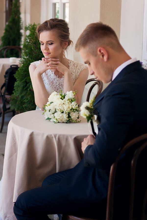 Wedding Couple Sitting at a Table on the Summer Terrace Stock Photo ...