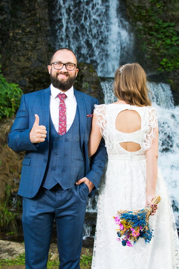 Wedding Couple Standing in Front of a Waterfall Stock Photo - Image of ...