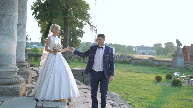 Wedding Couple Walking Near the Castle and Whirling. Slowly Stock ...