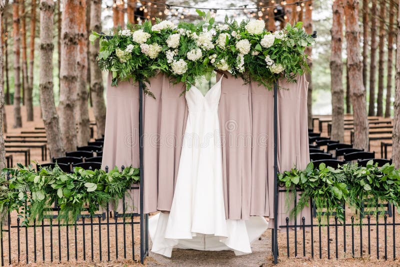 Wedding Dresses Hang in a Row, Surrounded by Greenery Stock Image ...