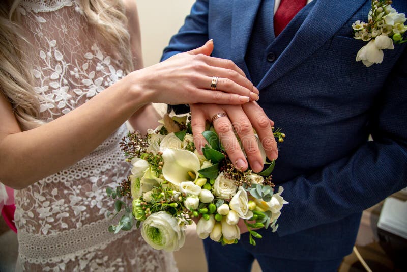Wedding Flowers and Newlyweds` Hands with Wedding Rings. Stock Image ...