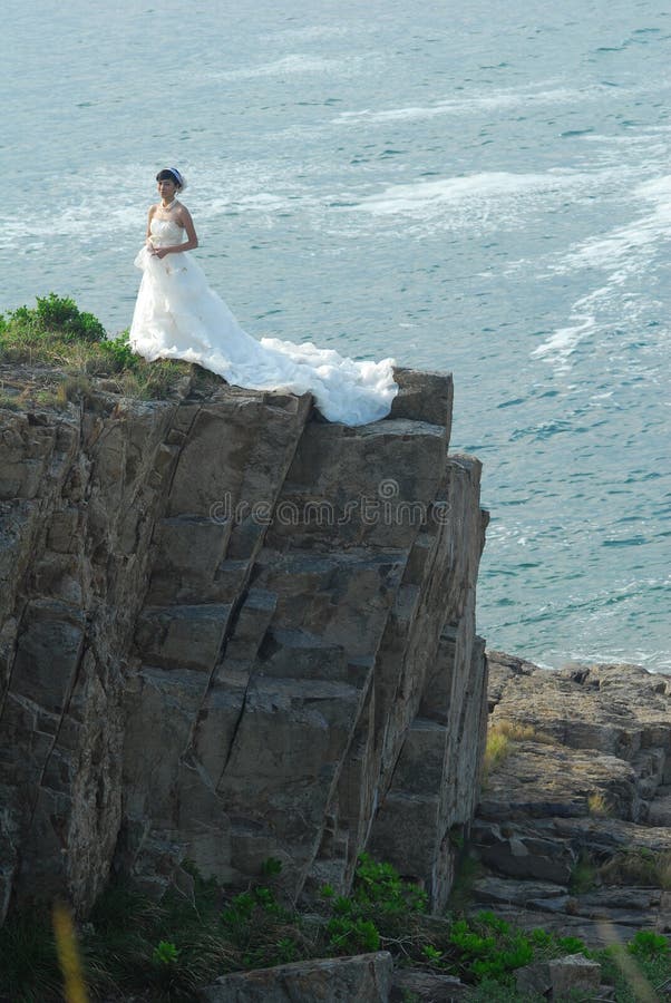 Wedding girl in Cliff stock image. Image of wedding, ocean - 26627663