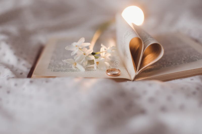 Wedding Golden Ring and Open Book with Folded Sheets in Heart Shape ...