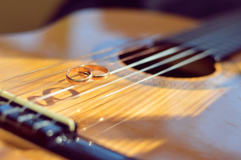 Two Wedding Rings are on Guitar Stripes Stock Photo - Image of mirror ...