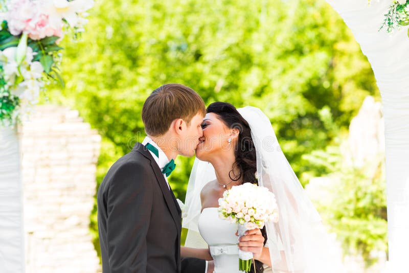 Wedding Pair Hugging and Kissing Stock Image - Image of flowers, groom ...