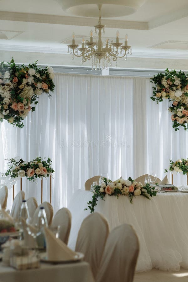 A Wedding Reception with a White Backdrop and Floral Decorations Stock ...