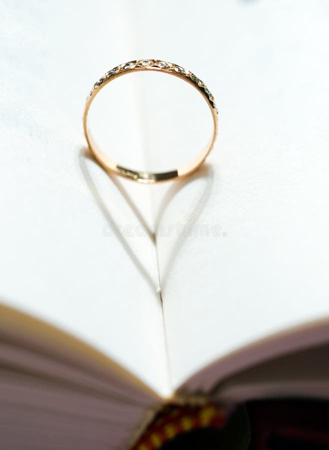 Ring Casting a Heart-shaped Shadow in a Book. Stock Photo - Image of ...