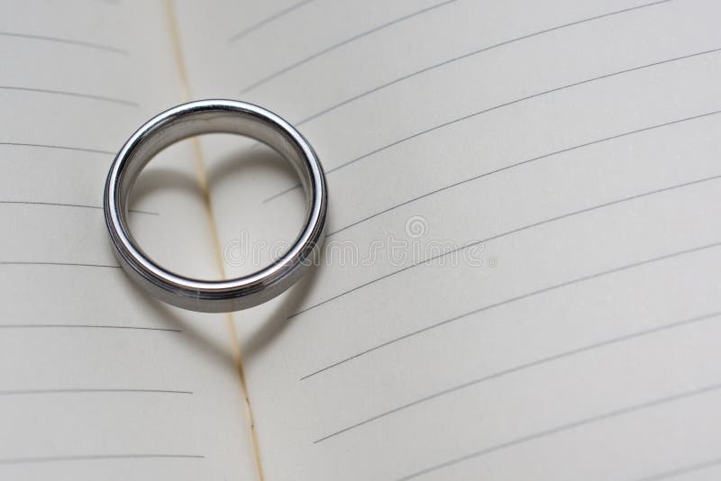 Wedding Ring Band on Book with Heart Shadow Close Up Angled View Stock ...