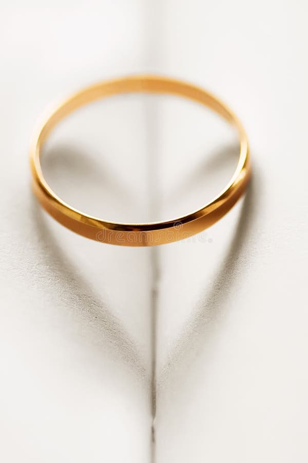 Wedding Ring Casting a Heart-shaped Shadow Stock Photo - Image of luck ...