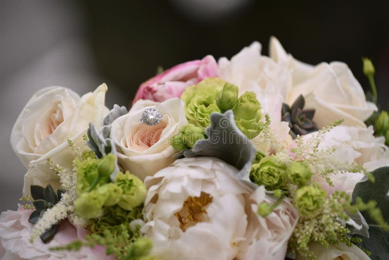 Wedding ring in flowers stock photo. Image of inside - 131515332