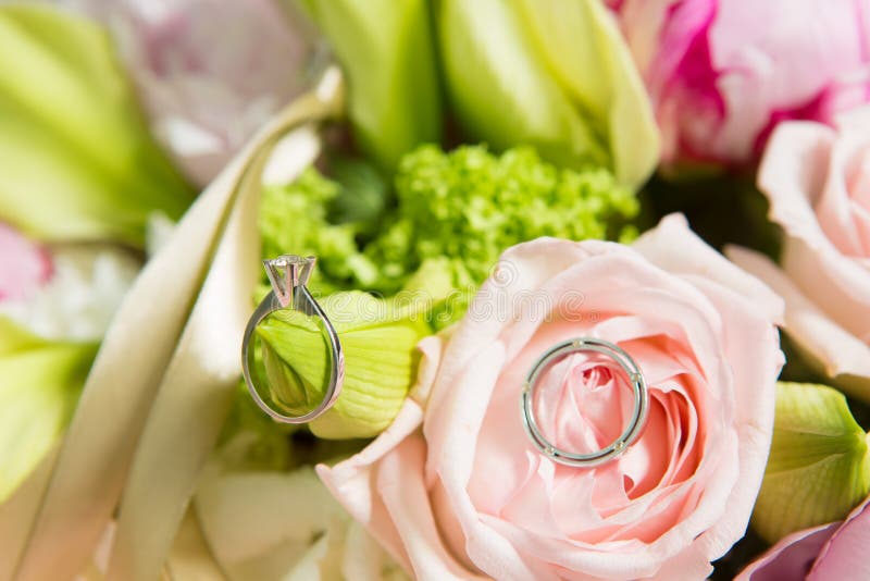 Wedding Rings and Beautiful Flowers. Stock Photo - Image of background ...