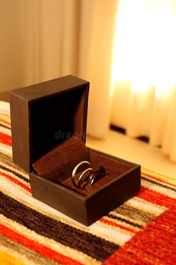 Wedding rings on the bed stock photo. Image of blankets - 18163066