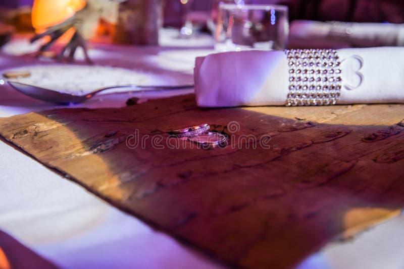 Wedding Rings on Birch Table Mats in Purple Light Stock Photo - Image ...