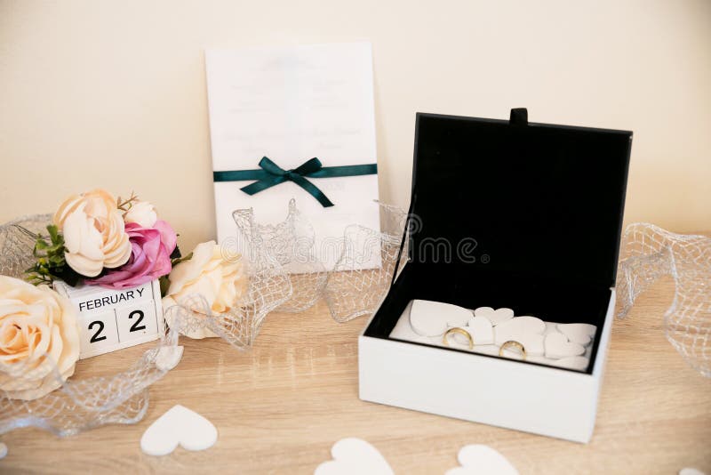 Wedding Rings in a Box,a Wedding Invitation and a Wooden Object with ...