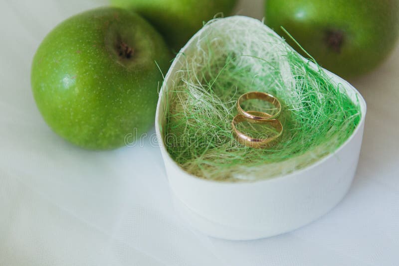 Wedding Rings in the Cassette Near Green Apples Stock Image - Image of ...