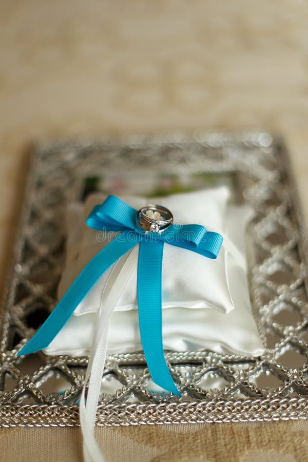 Wedding Rings on a Cushion with Blue Ribbon Stock Photo - Image of ...