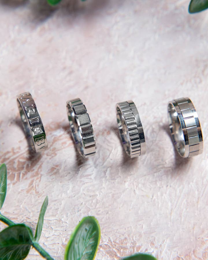 Wedding Rings Displayed on Textured Surface with Greenery Stock Image ...