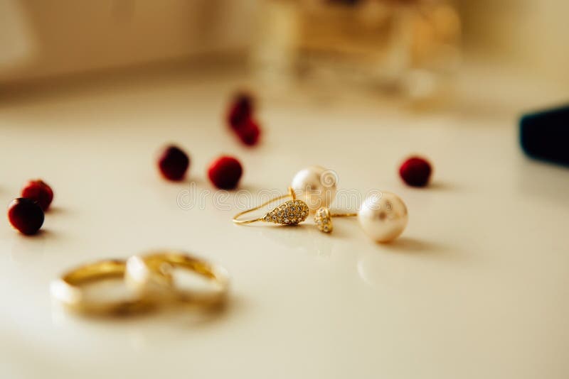 Wedding Rings and Earrings on Table Stock Photo - Image of object ...