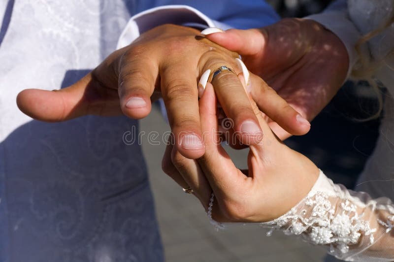 Wedding rings on fingers stock image. Image of bows, feast - 11191061