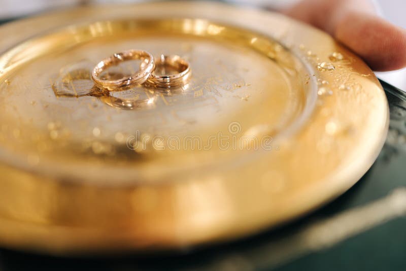 Wedding Rings on Golden Platter in Church Stock Image - Image of ...