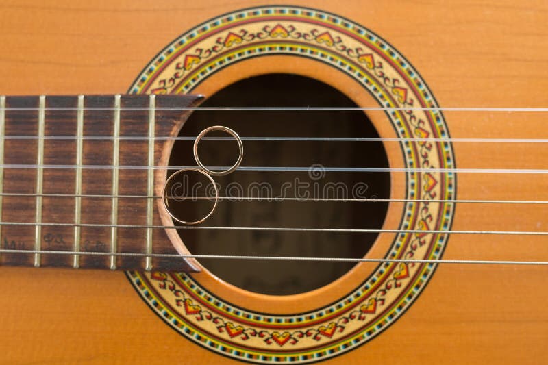 Wedding rings on guitar stock image. Image of gold, anniversary - 66504143