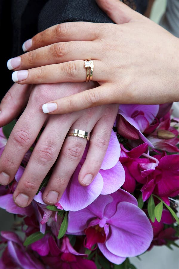 Wedding Rings and Hands Over Bridal Bouquet Stock Image - Image of ...