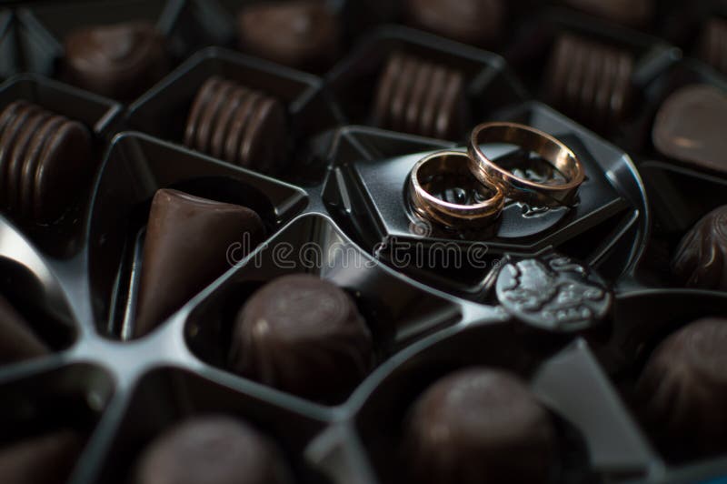 Wedding Rings Lie on the Chocolate Box Stock Photo - Image of marriage ...