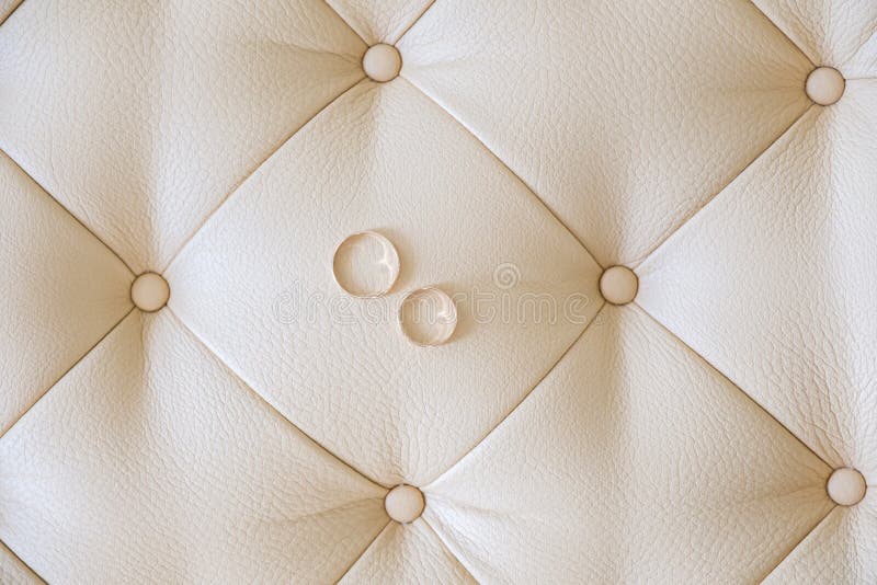 Wedding Rings on a Light Leather Sofa. Top View. Stock Image - Image of ...