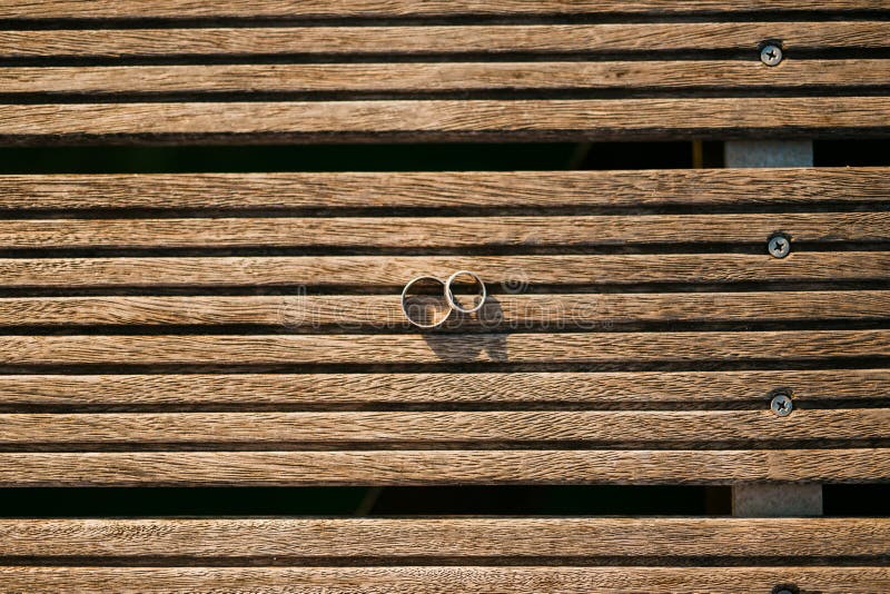 Wedding Rings on a Light Wooden Texture Stock Image - Image of golden ...