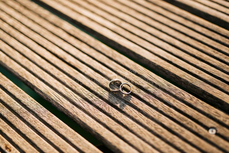 Wedding Rings on a Light Wooden Texture Stock Photo - Image of luxury ...
