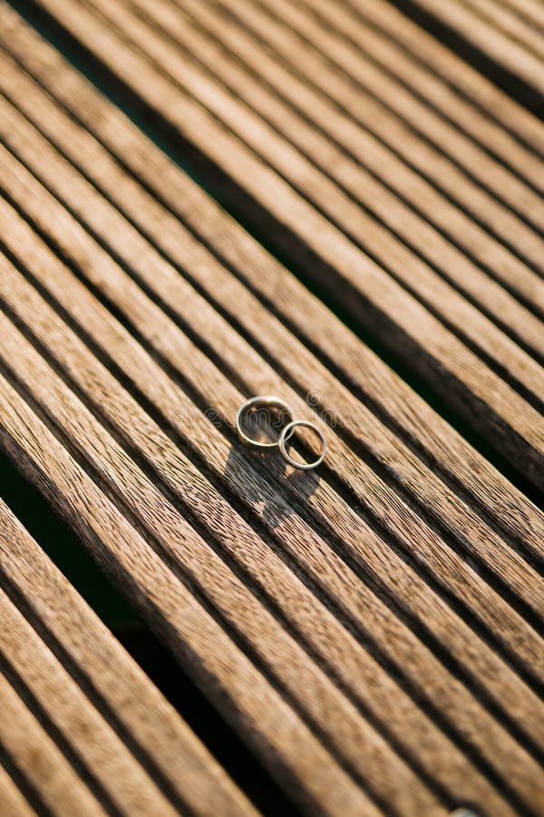 Wedding Rings on a Light Wooden Texture Stock Photo - Image of pair ...
