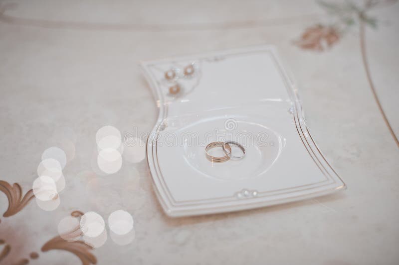 Wedding rings on a plate stock photo. Image of restaurant - 54218028