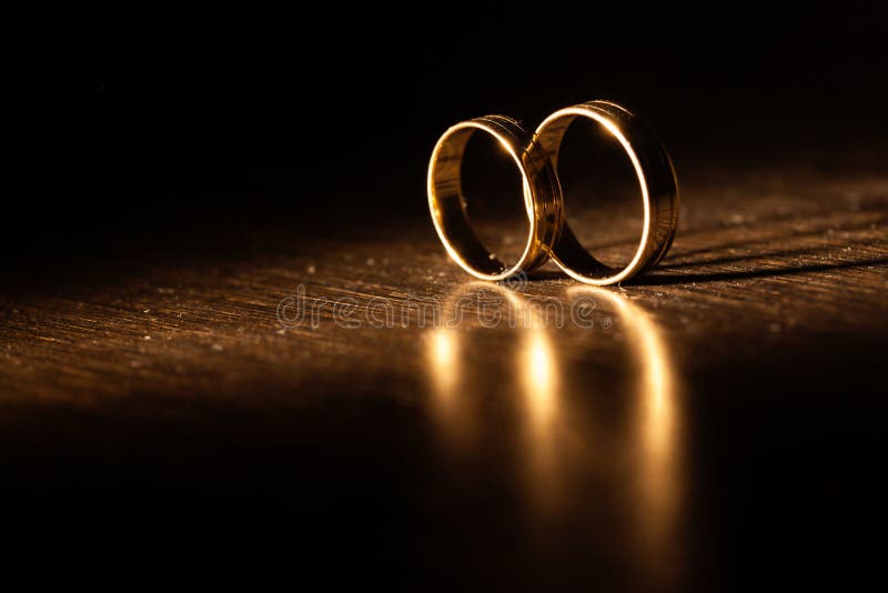 Wedding Rings in Rays of Light with a Beautiful Shadow Stock Photo ...