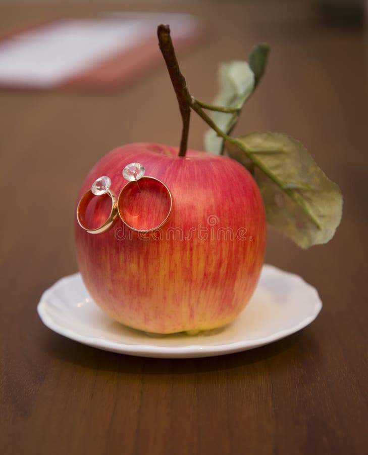 Wedding Rings on a Red Apple Stock Image - Image of sweetheart, gold ...