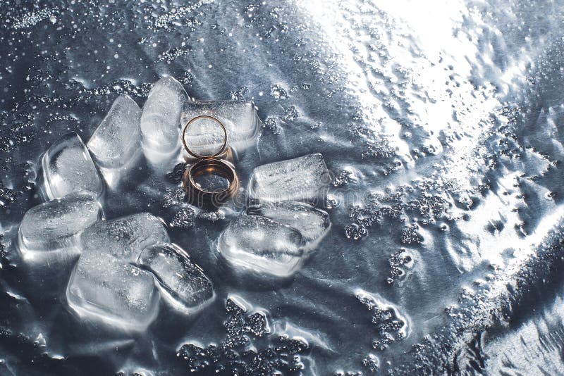Wedding Rings with Splashes of Water and Pieces of Ice. Wedding Concept ...