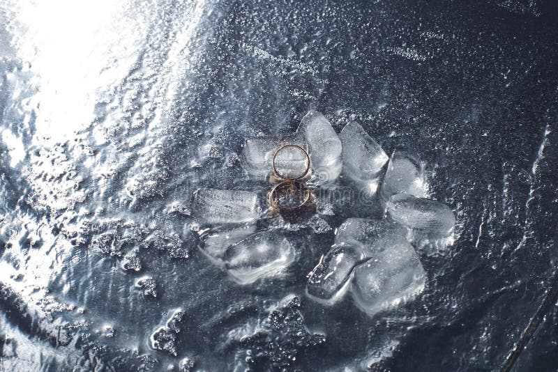 Wedding Rings with Splashes of Water and Pieces of Ice. Wedding Concept ...