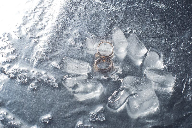 Wedding Rings with Splashes of Water and Pieces of Ice. Wedding Concept ...